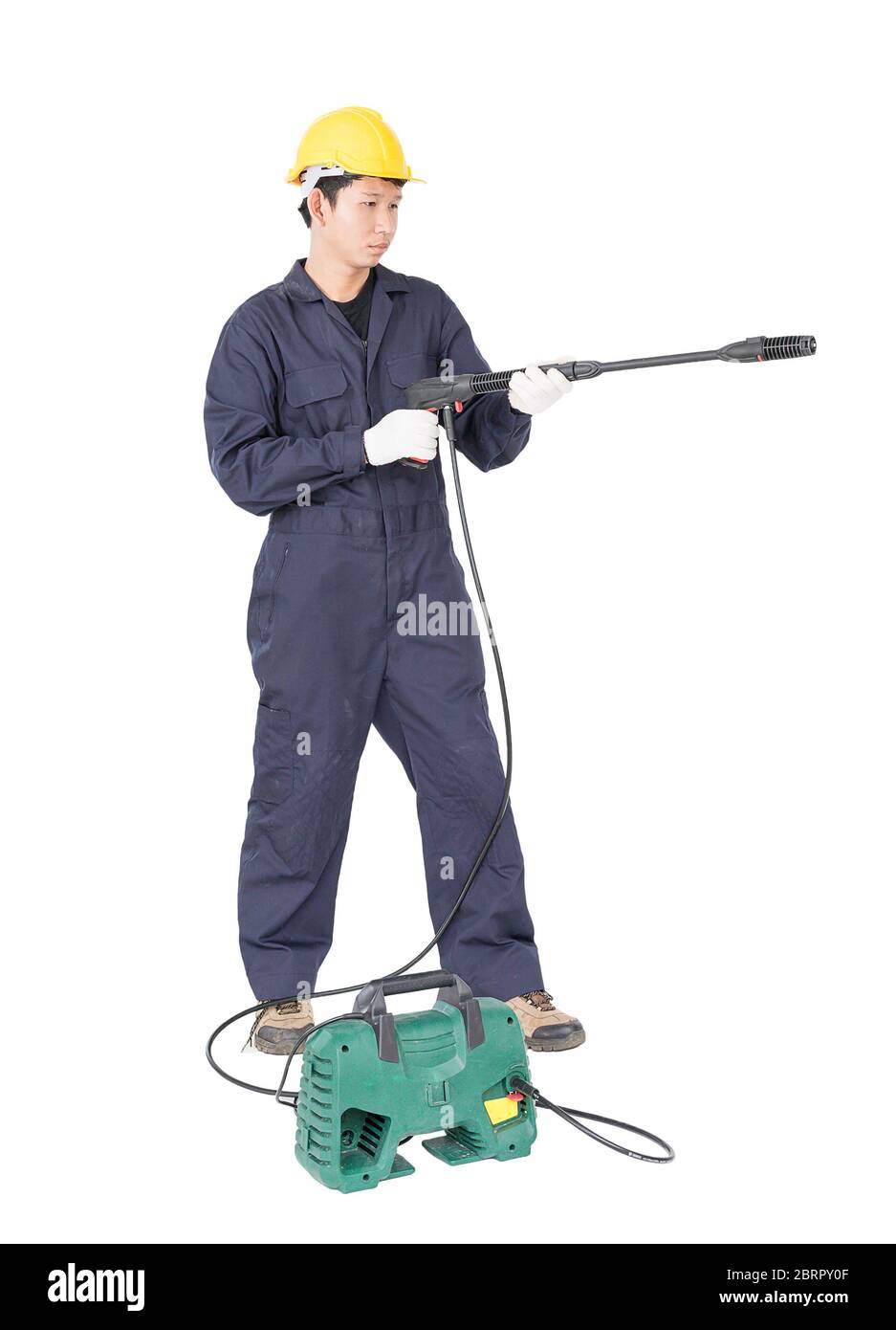 Young man in uniform stand and holding high pressure water gun portable ...