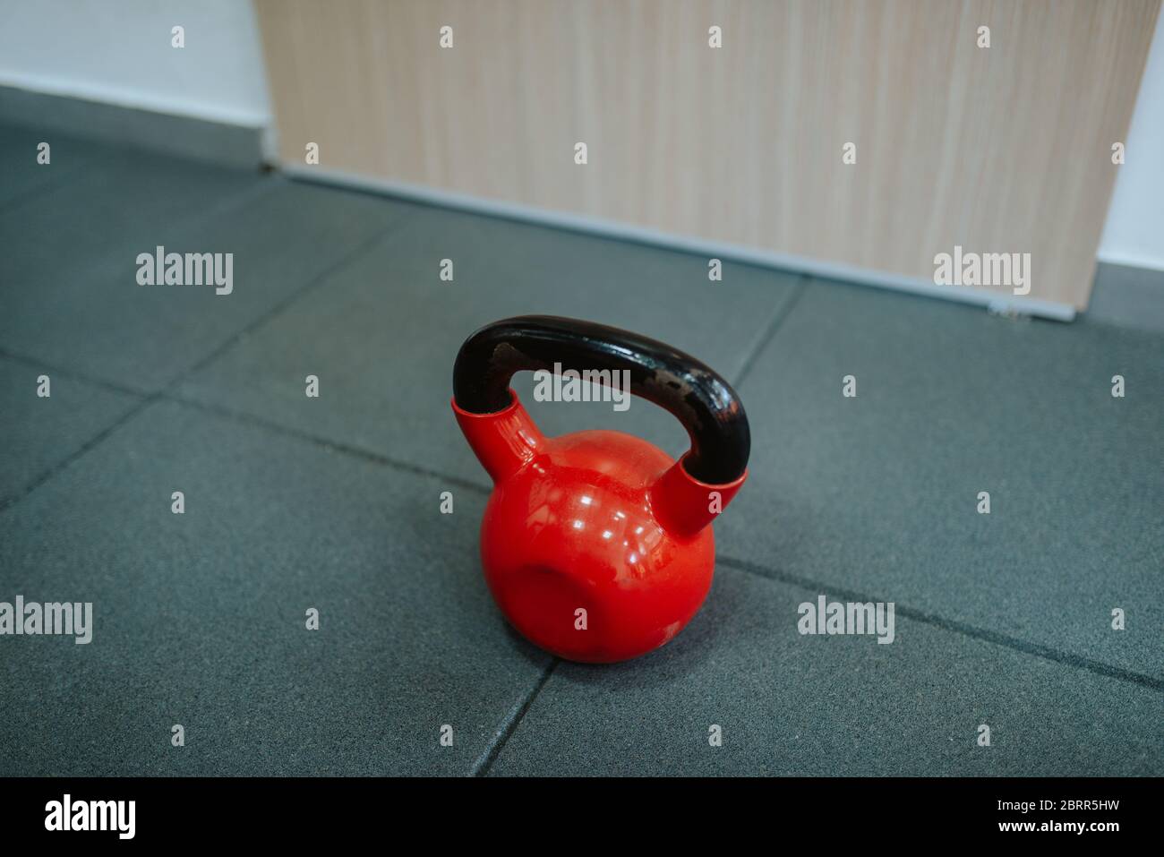 Red barbell on the gym floor Stock Photo - Alamy