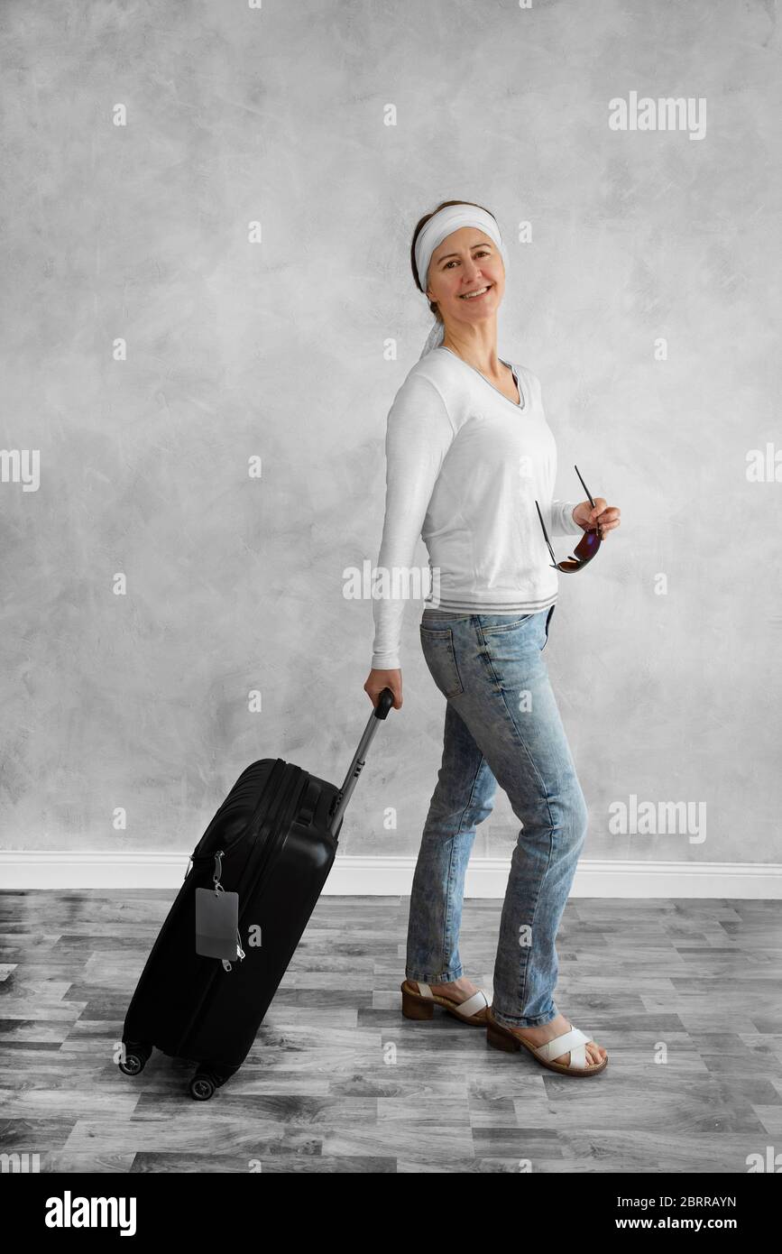 Woman walks with luggage hi-res stock photography and images - Alamy
