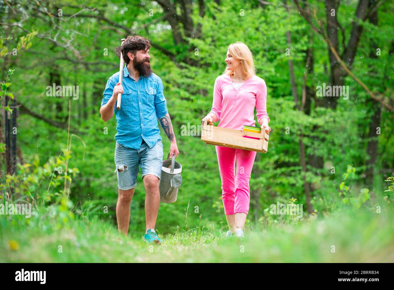 Couple of farmers walking in agricultural field. Summer farming ...