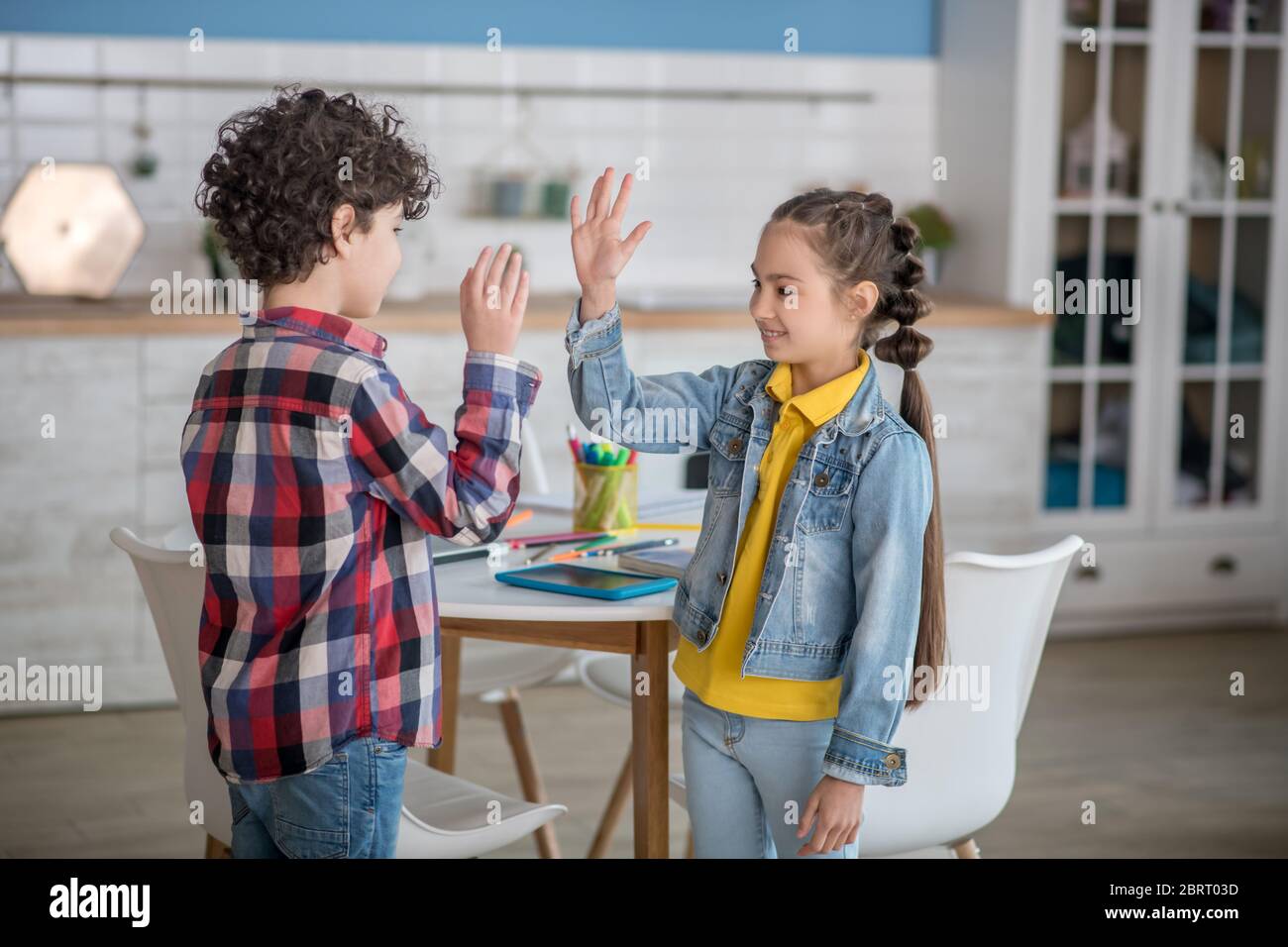 Happy children giving high five hi-res stock photography and images - Alamy