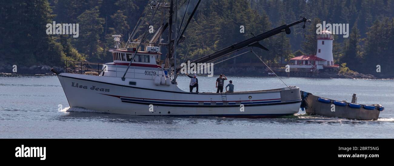 Fishing boat Lisa Jean sailing in marina. Lighthouse and forest in soft ...