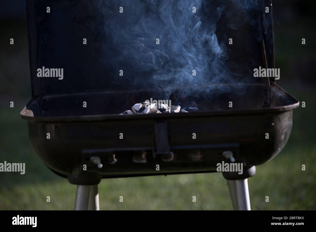 Smoking charcoal with small flame Stock Photo - Alamy
