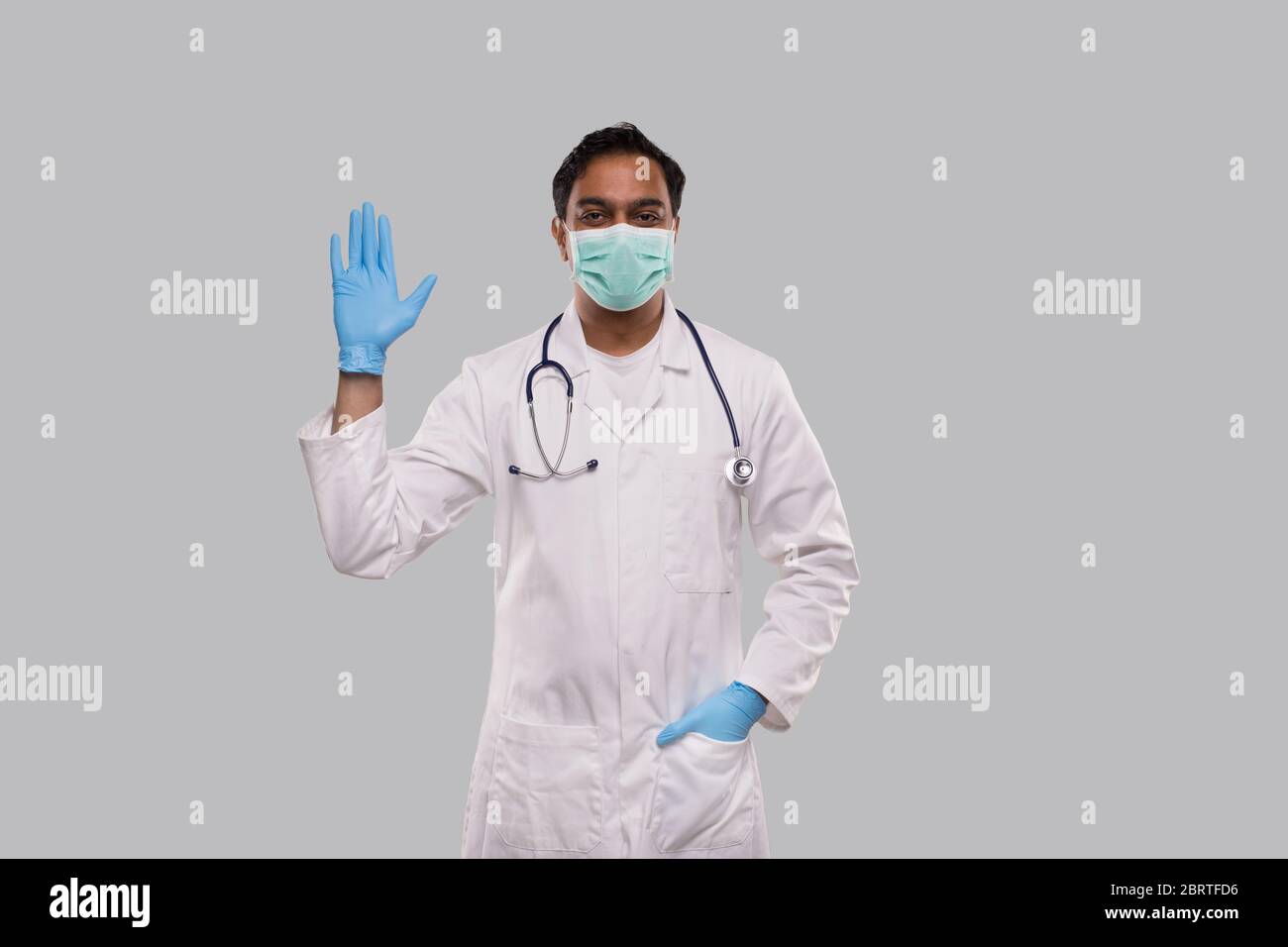 Doctor Waving Hand Wearing Medical Mask and Gloves Isolated. Indian Man ...