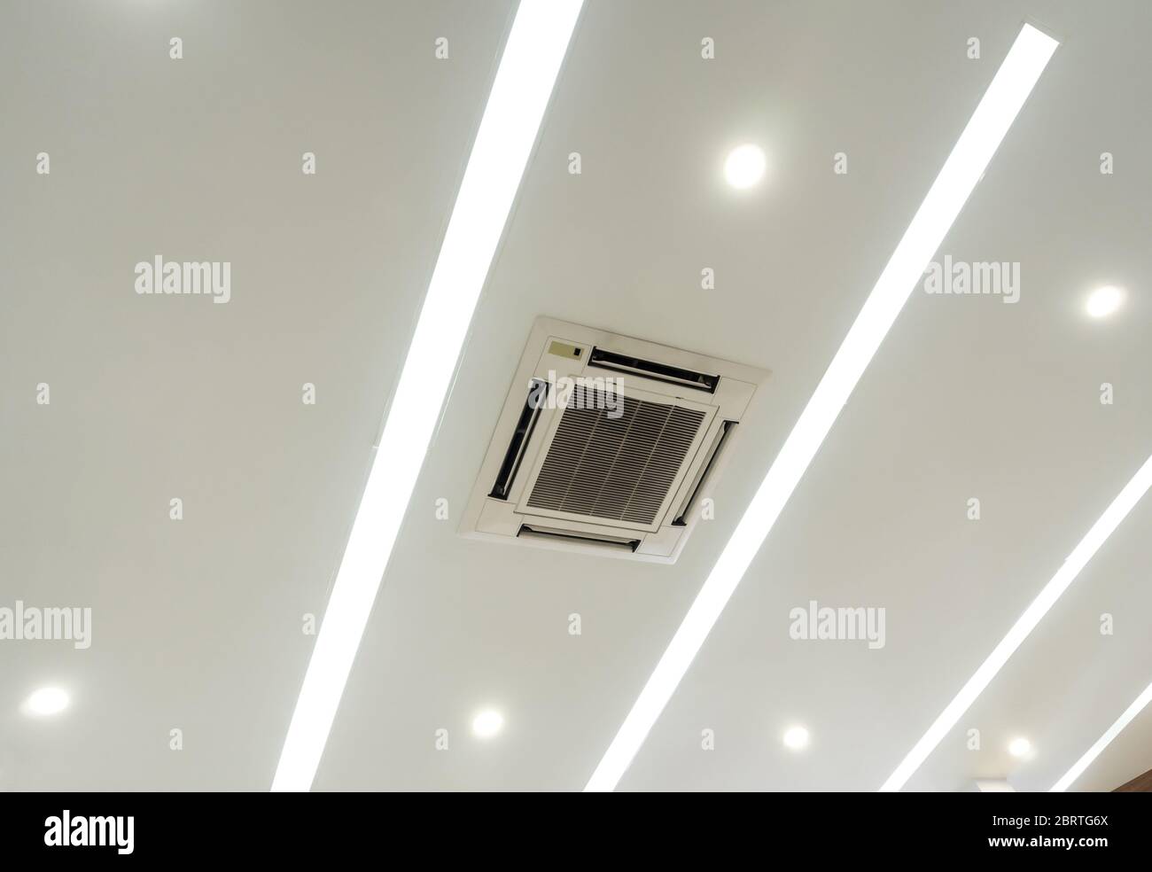 Lighting and ceiling mounted air conditioner on the modern office ...