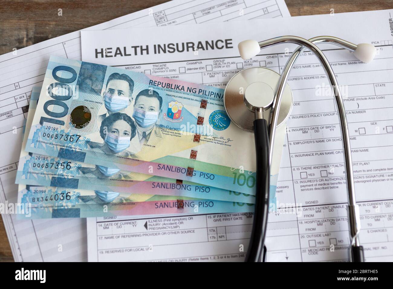 One thousand Philippines peso with face mask on insurance paper bill ...