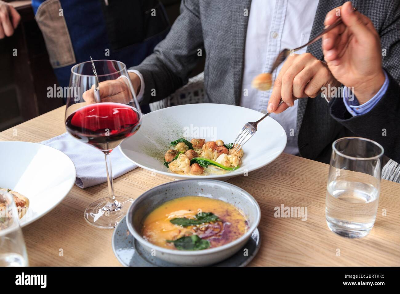 Man is eating in a restaurant and enjoying delicious food Stock Photo ...