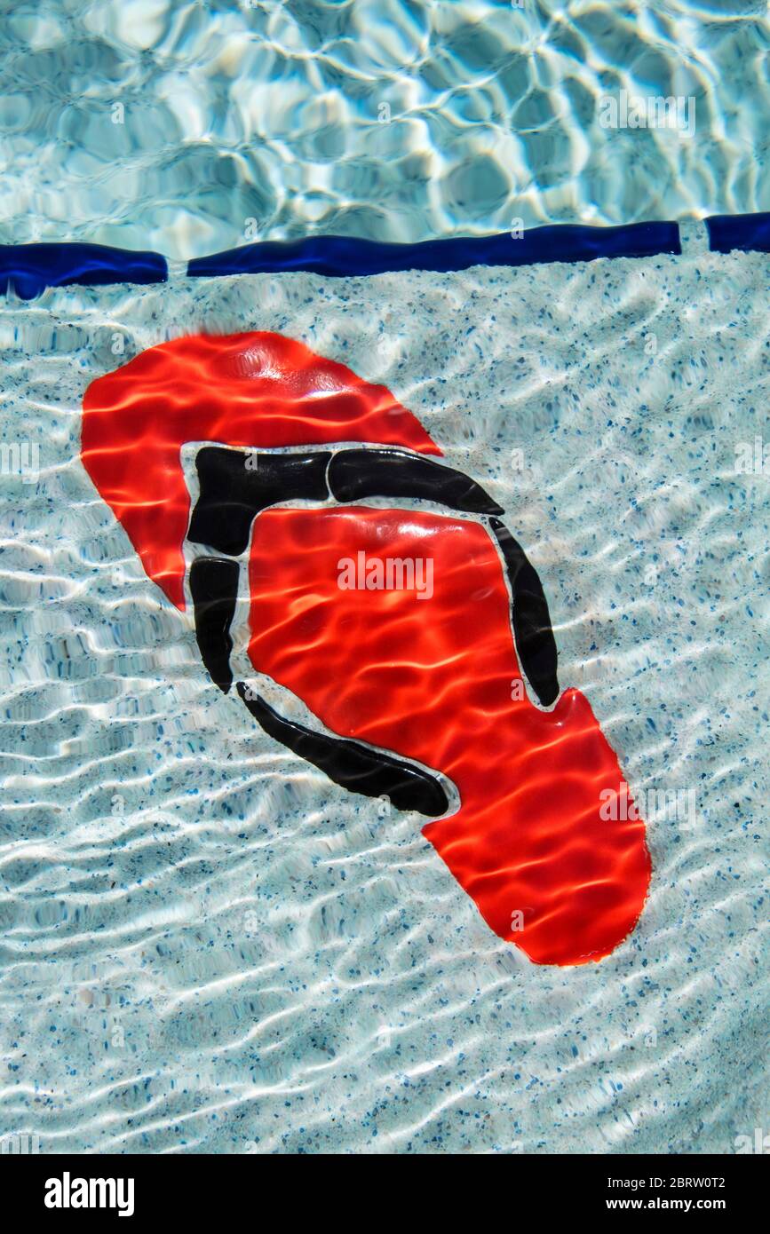 Flip flop design tiles at bottom of swimming pool Stock Photo - Alamy