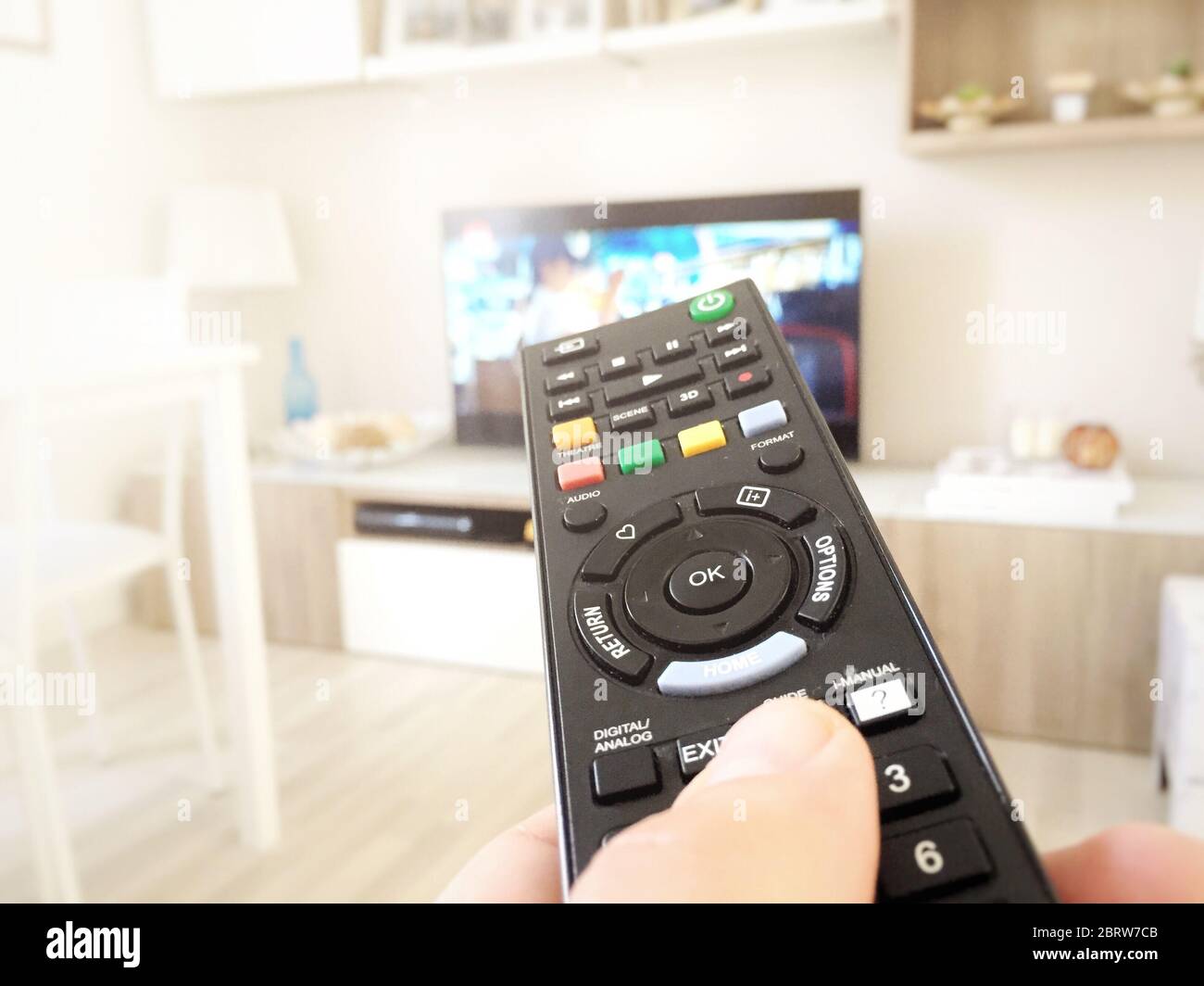 Hand hold the remote control to change channels on Television Stock ...