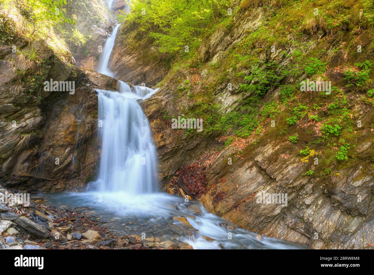 Three-stage waterfall in the spring in the mountains Stock Photo - Alamy