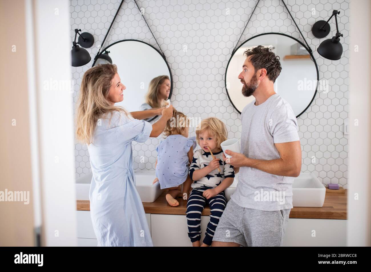 Young family with two small children indoors in bathroom, talking Stock ...