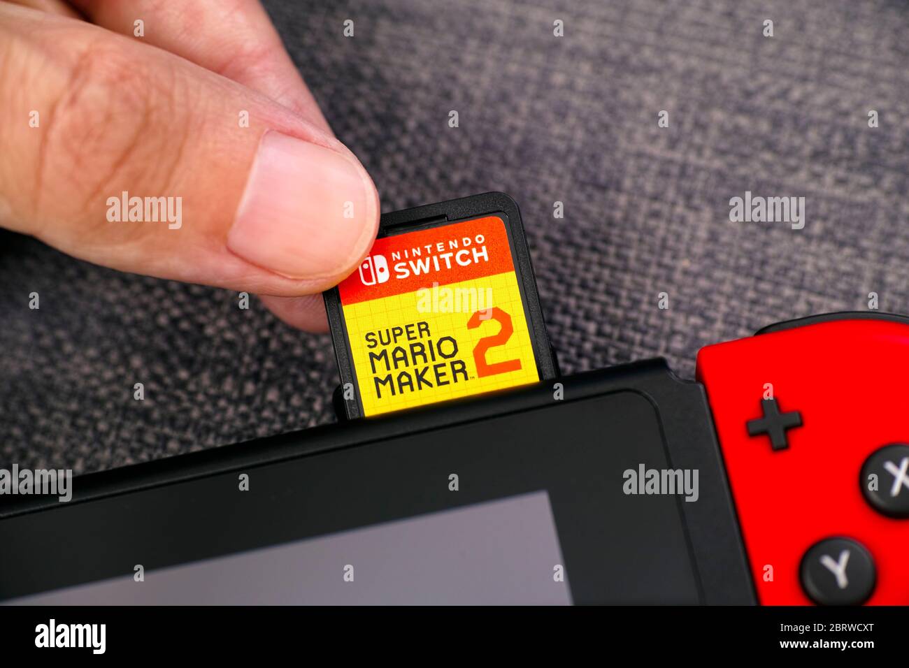 Tambov, Russian Federation - July 09, 2019 Man fingers inserting Super ...