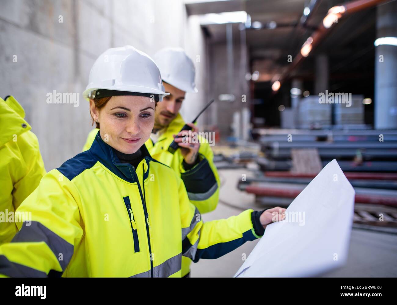 A group of engineers standing on construction site, working Stock Photo ...