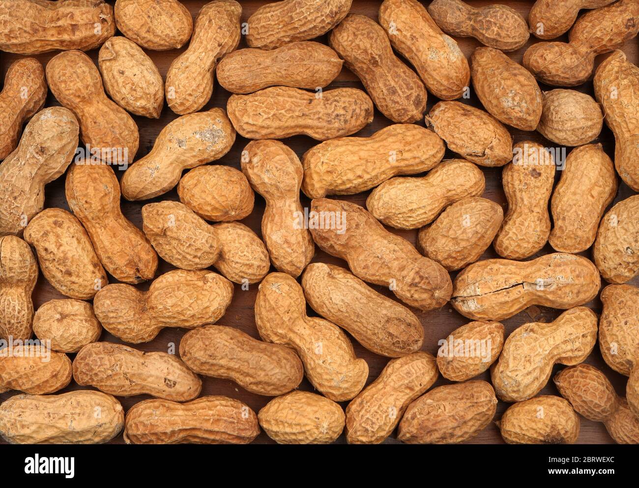 Organic shelled peanuts. For texture or background Stock Photo - Alamy