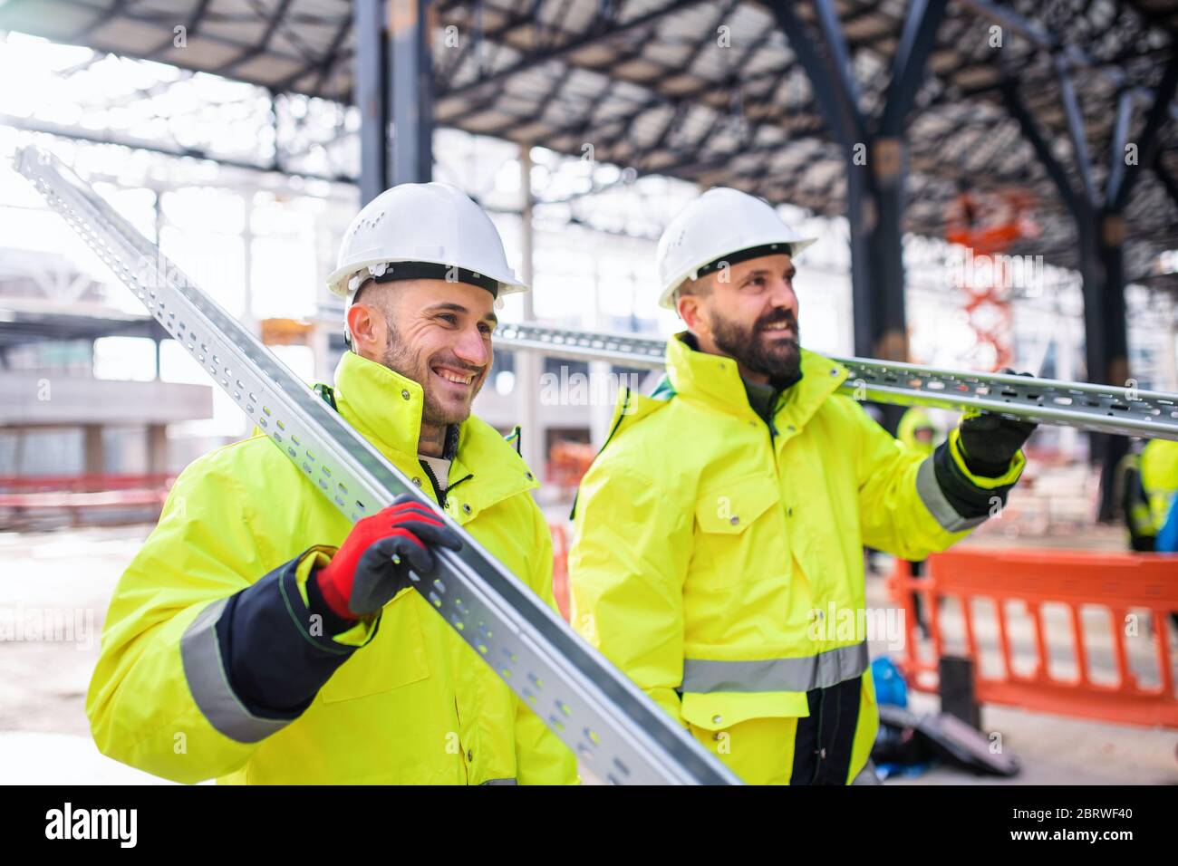 Men workers walking outdoors on construction site, working Stock Photo ...