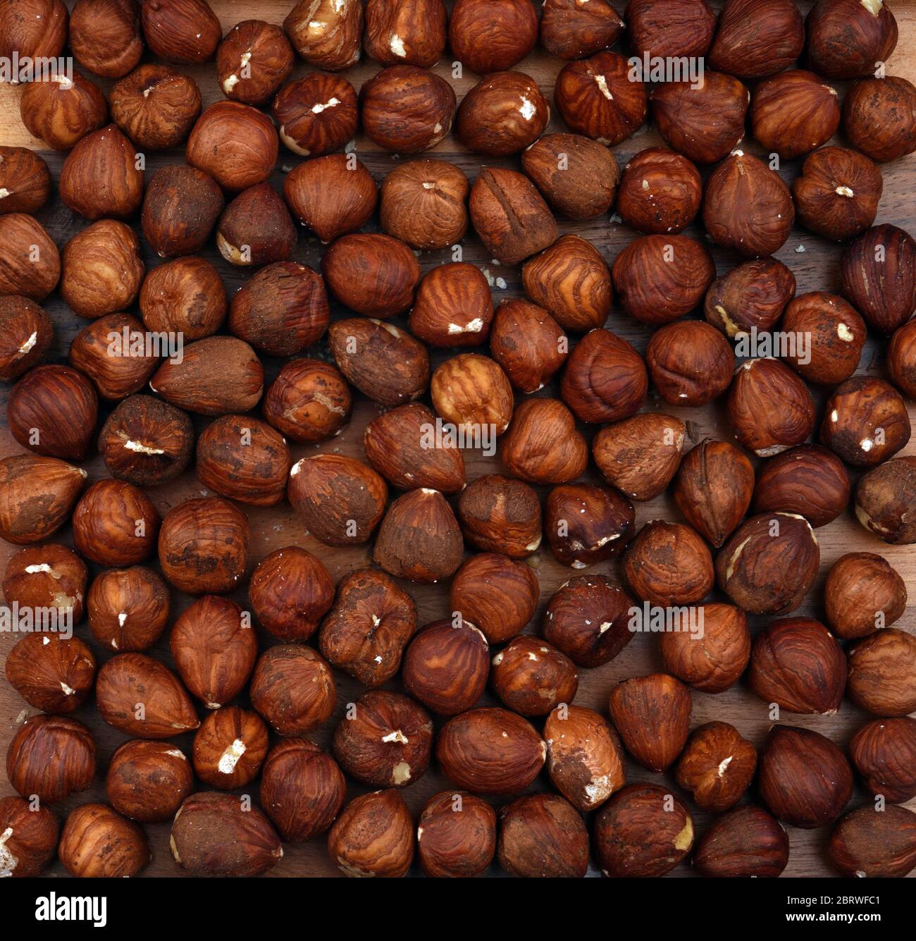 Organic unpeeled hazelnuts. For texture or background Stock Photo - Alamy
