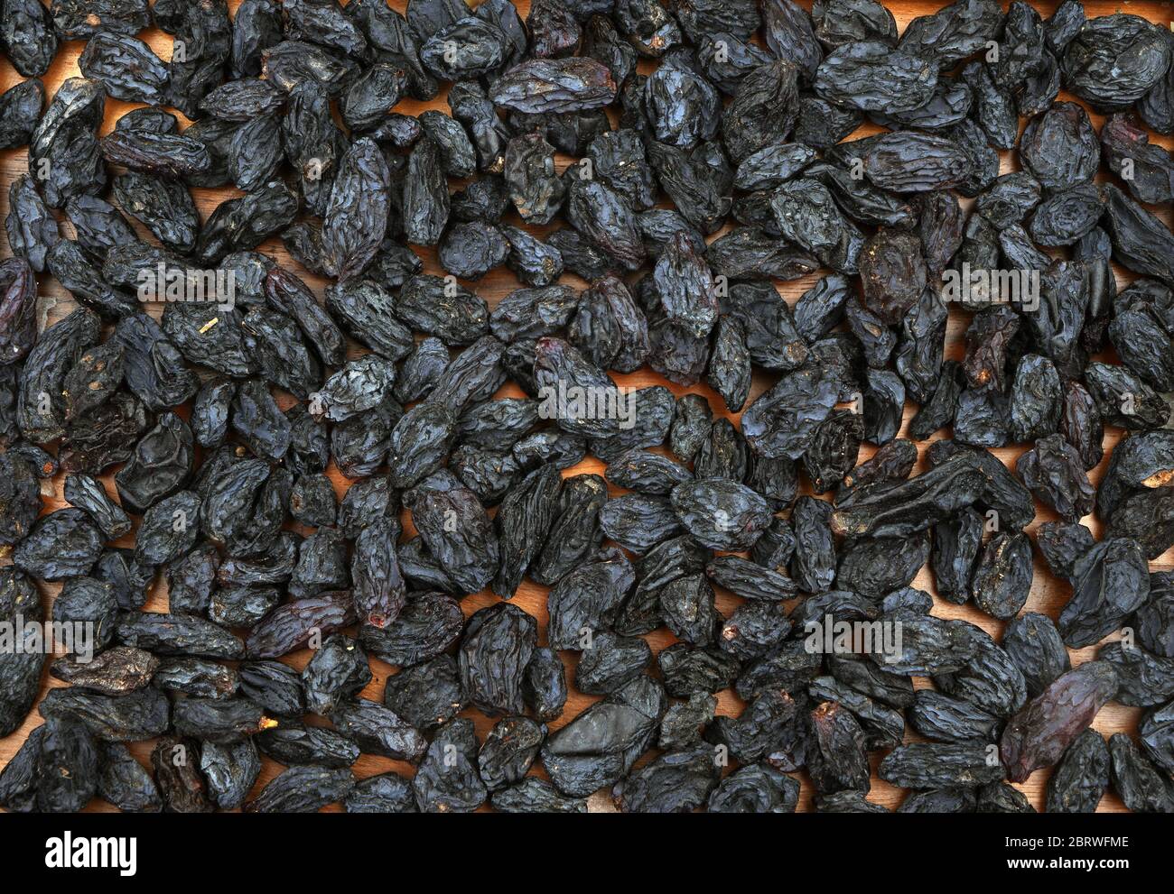 Organic big black raisins. For texture or background Stock Photo - Alamy