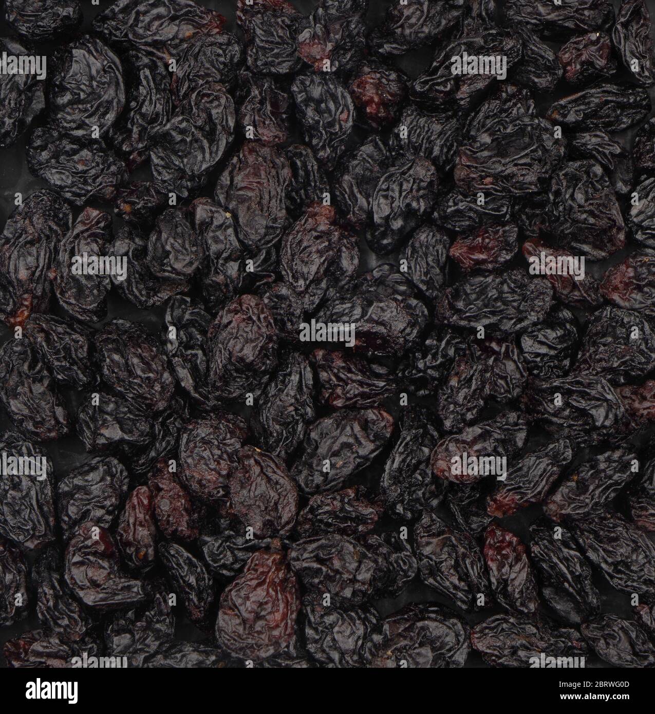 Organic black seedless raisins. For texture or background Stock Photo ...