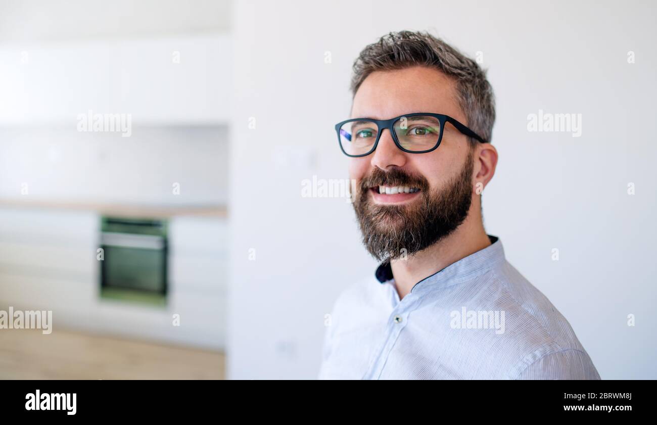 Mature man standing in house, moving in new home concept Stock Photo ...