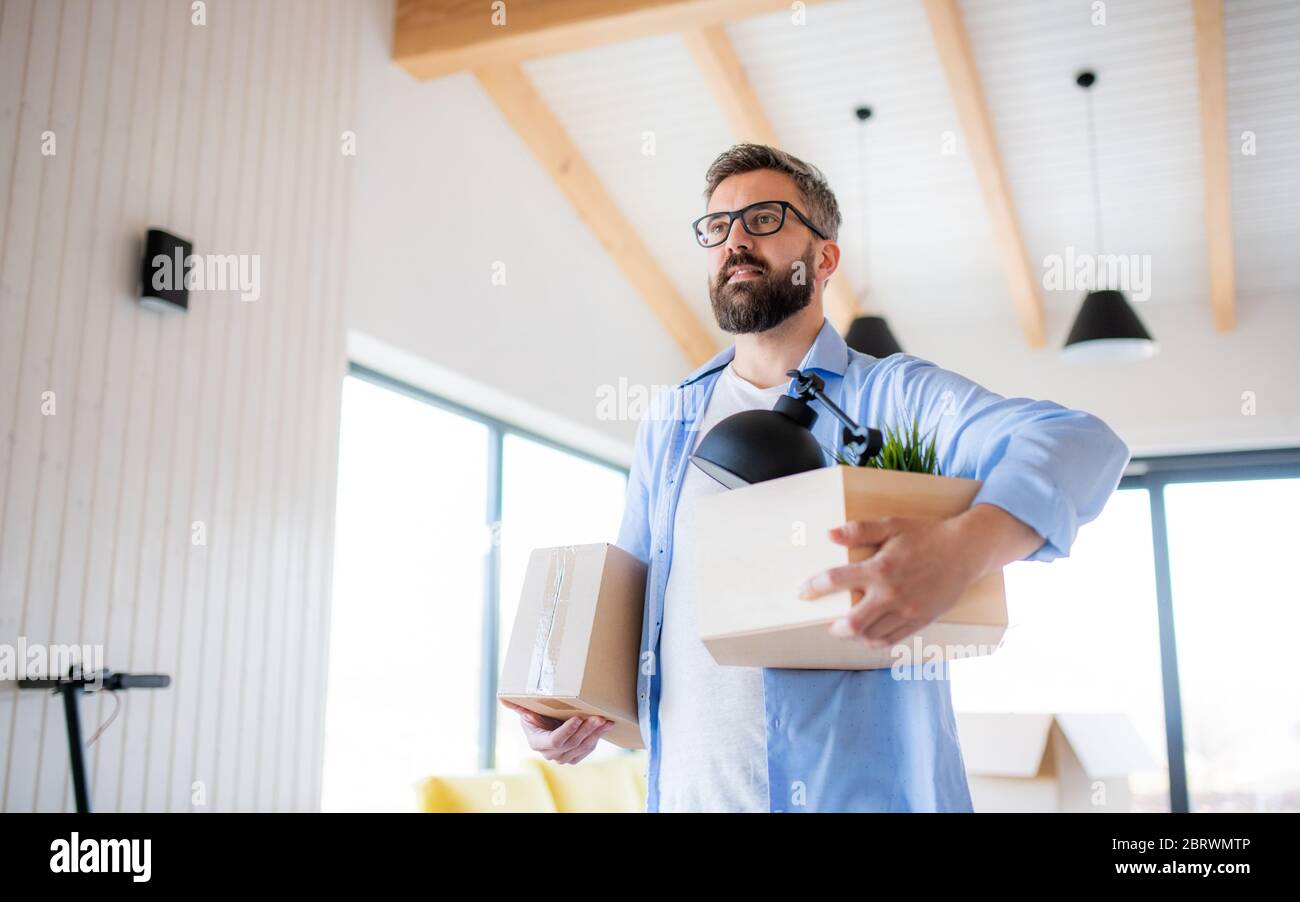 Man walking with boxes hi-res stock photography and images - Alamy