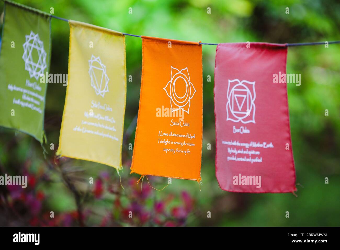 Chakra Prayer flags hanging in the breeze. The orange flag is the ...