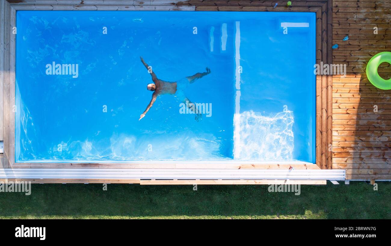 Top view of man swimming in water in swimming pool outdoors Stock Photo ...