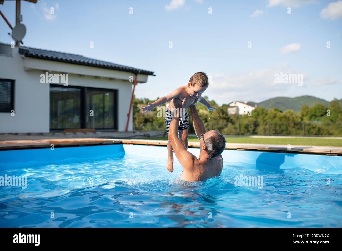 Father son playing in pool hi-res stock photography and images - Alamy