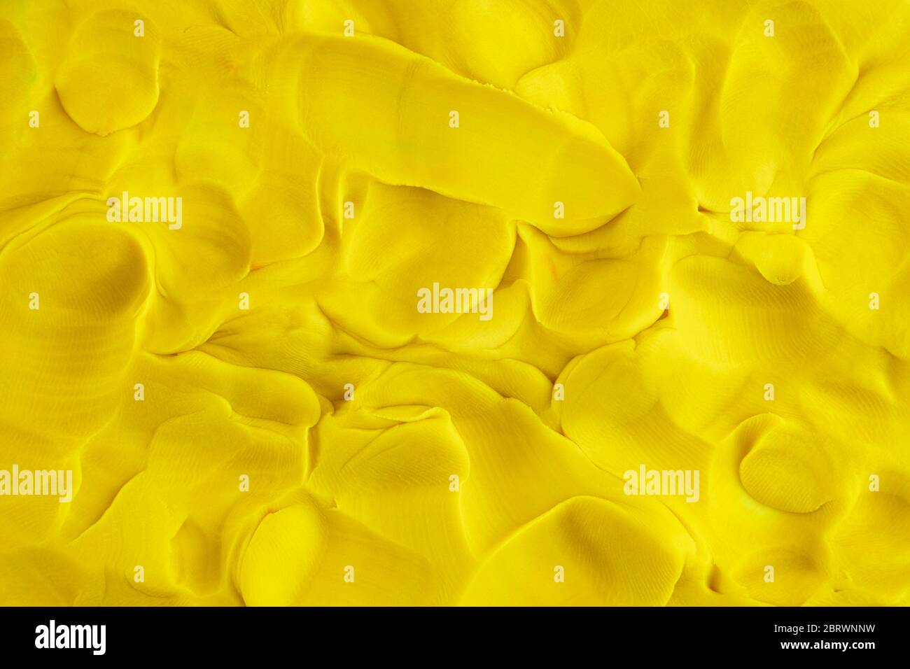 Play clay yellow background texture. Close up Stock Photo - Alamy