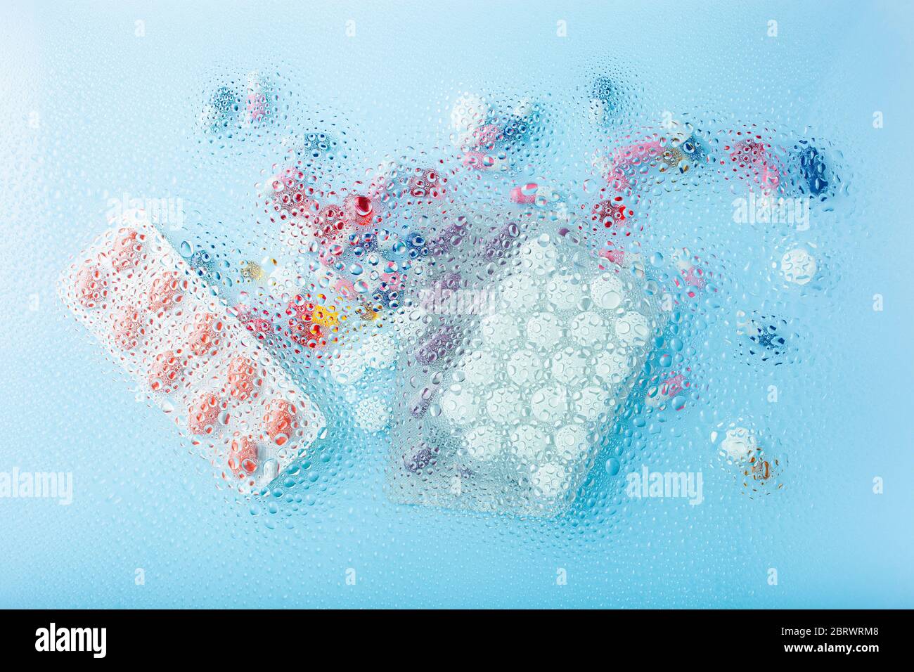 pill tablet capsule medicine through water drops background Stock Photo ...