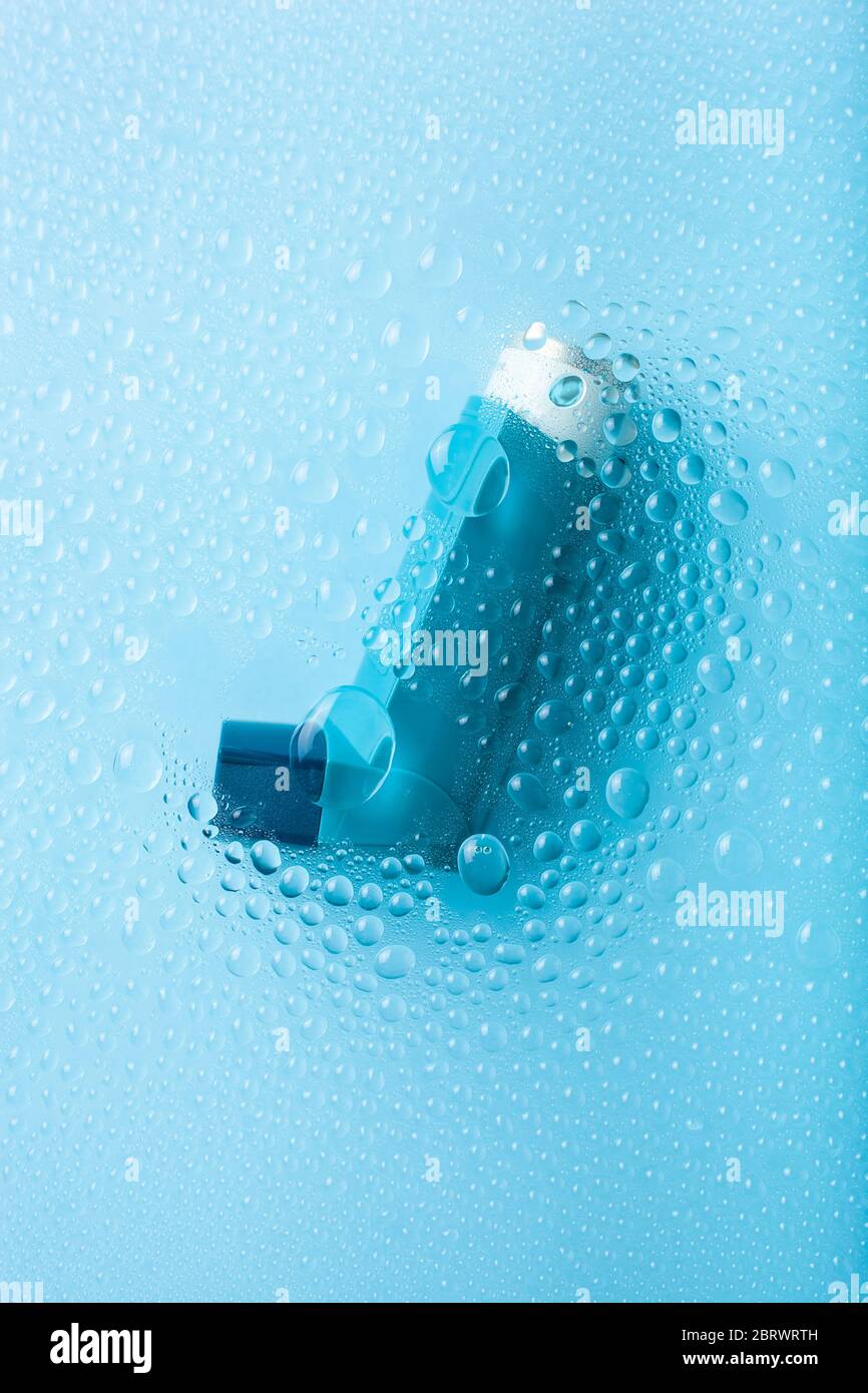 asthma inhaler medicine through water drop background. medical ...