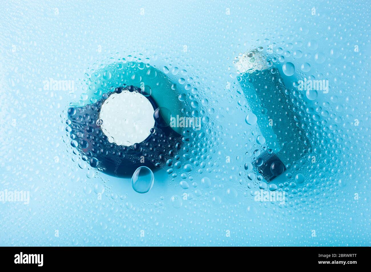 asthma inhaler medicine through water drop background. medical ...