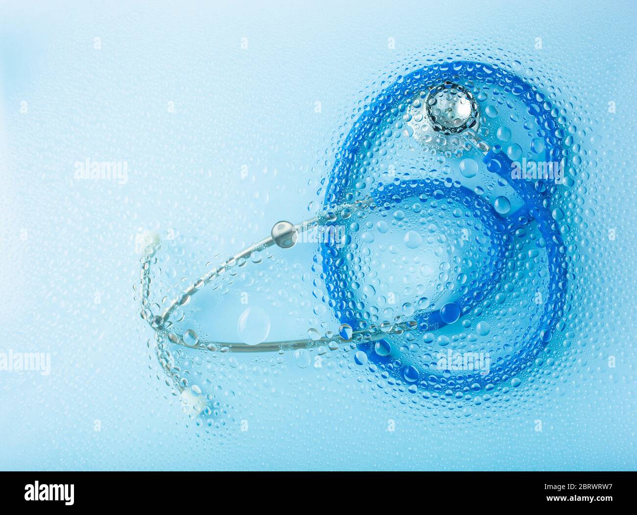 stethoscope through water drop wet background. medical tool examination ...