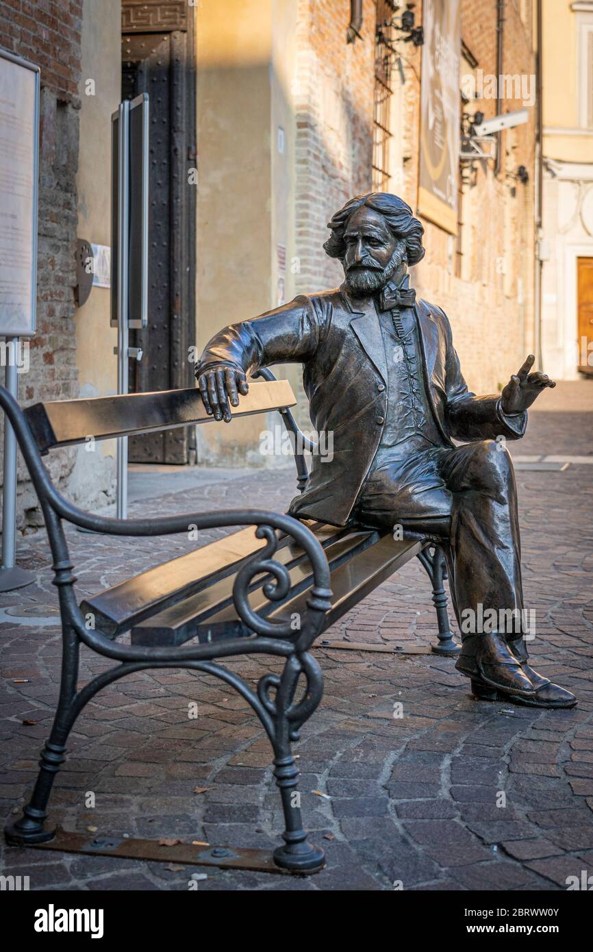 Statue of Giuseppe Verdi sitting on a bench in Piazza San Francesco ...