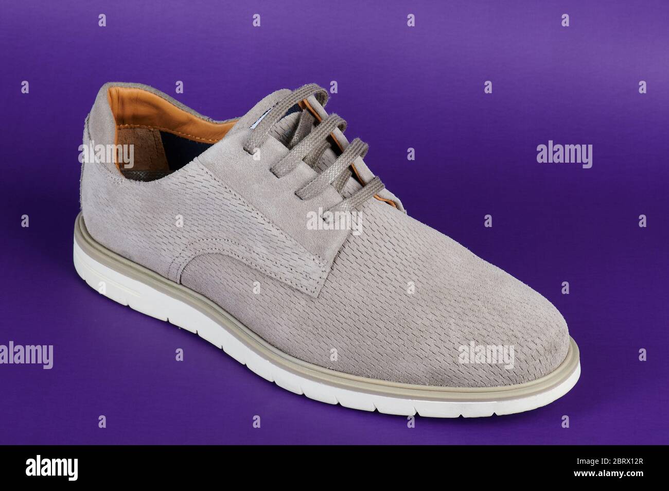 Clean gray casual shoe isolated on purple background Stock Photo - Alamy