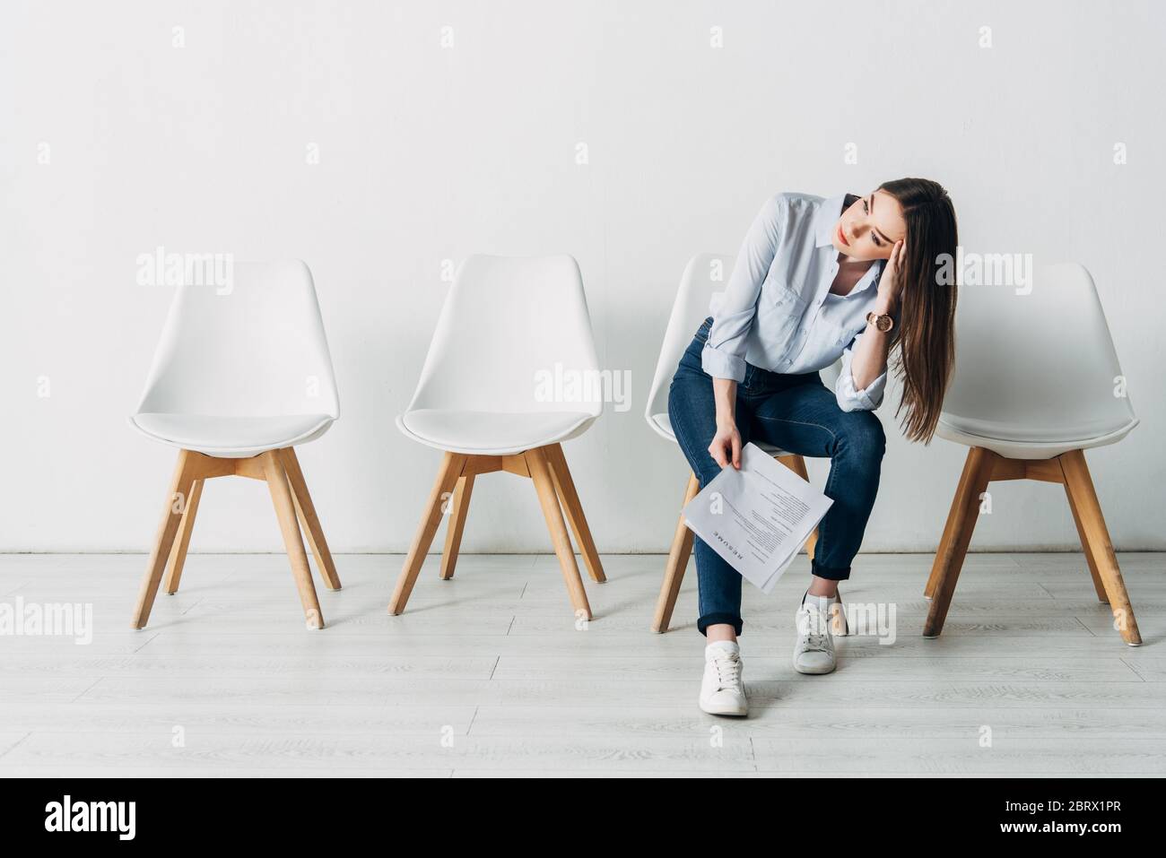 Tired employee with resume waiting for job interview in office Stock ...