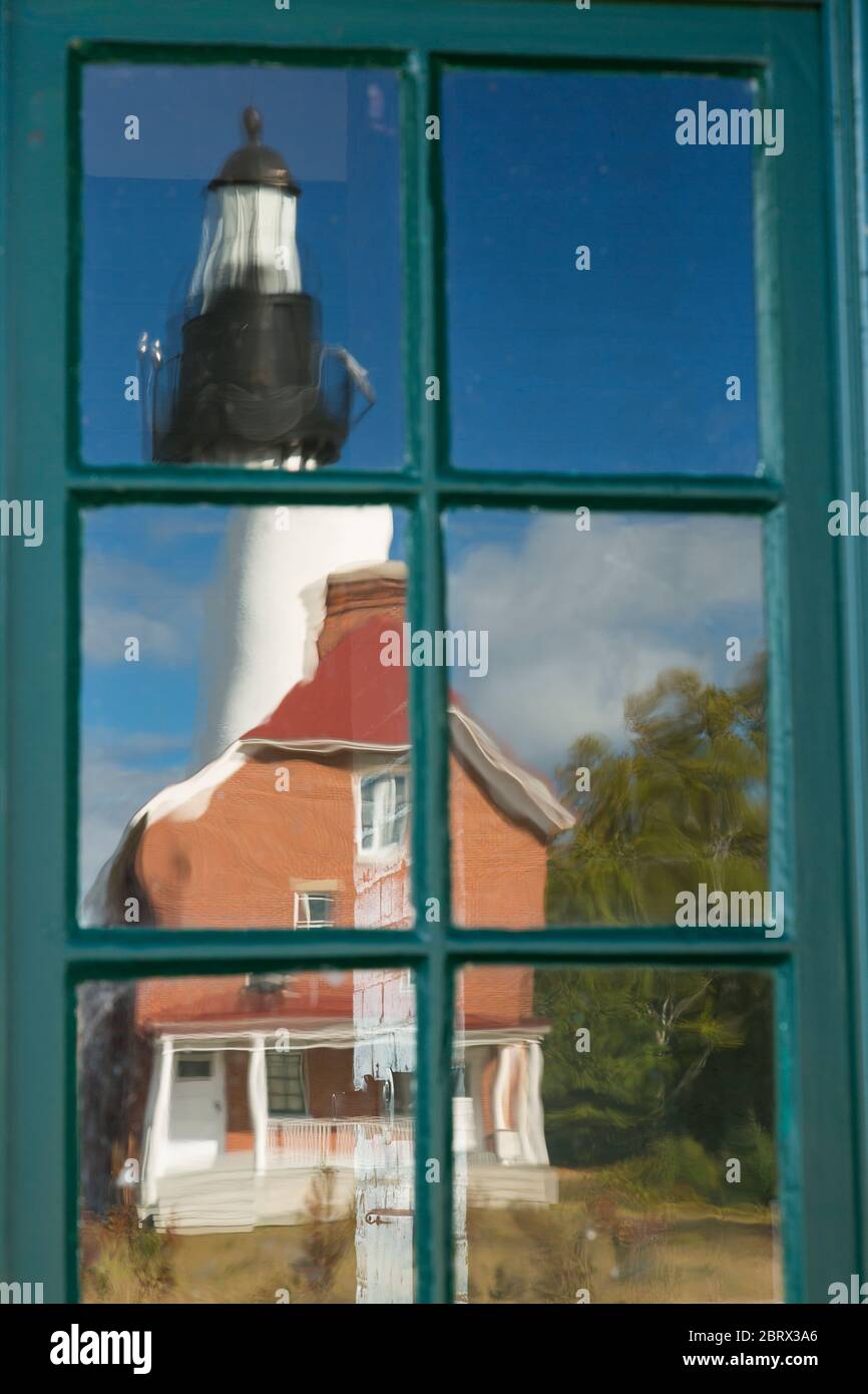 Au Sable Lighthouse Reflecting In A Window Stock Photo - Alamy