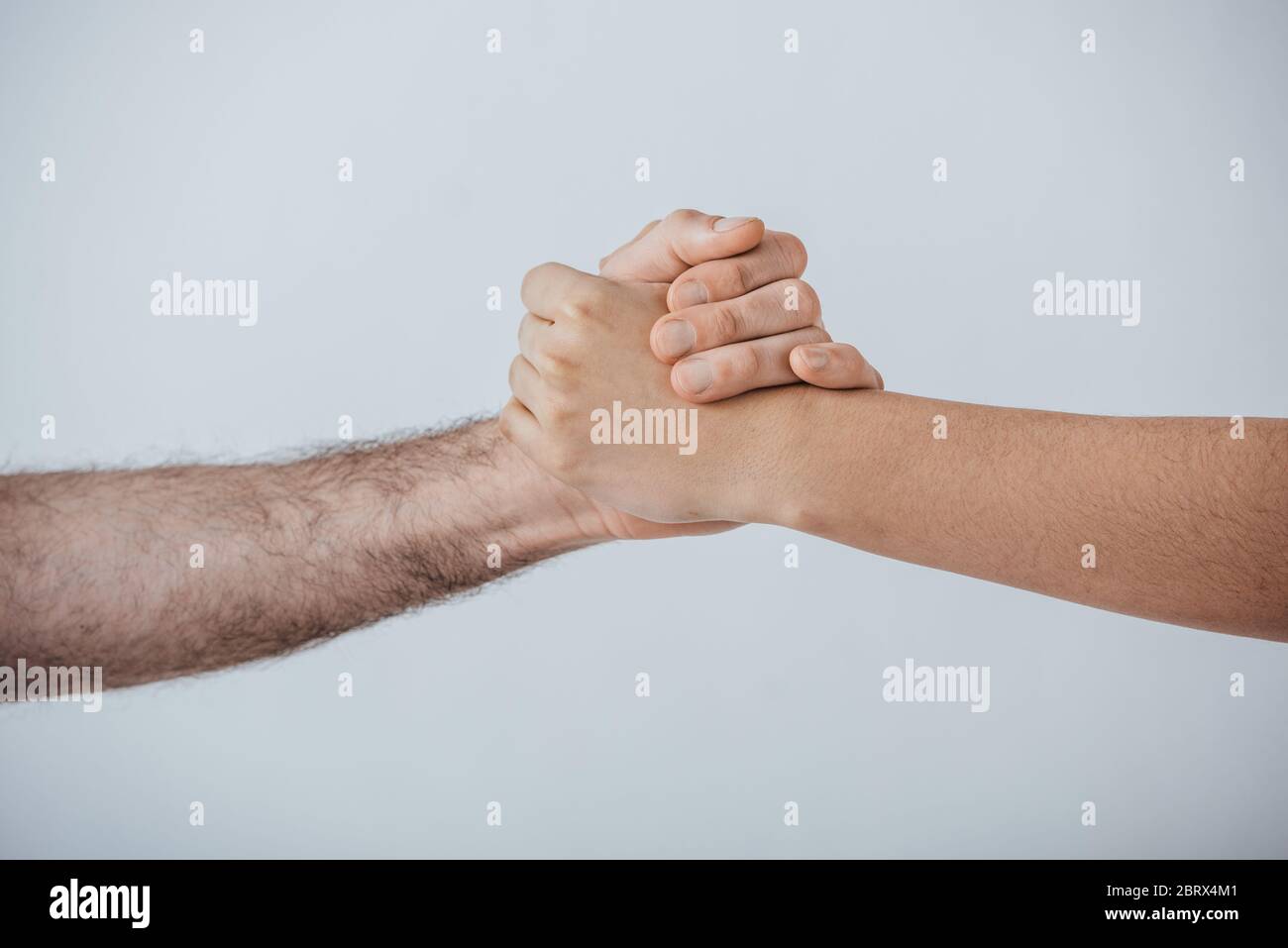 Cropped view of two men holding hands isolated on grey Stock Photo - Alamy