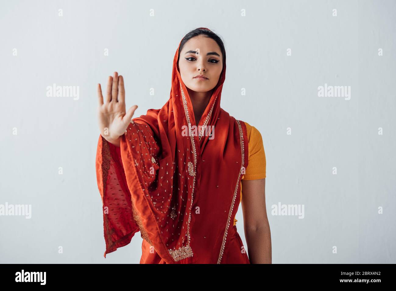 Beautiful indian woman in sari showing stop sign isolated on grey Stock ...