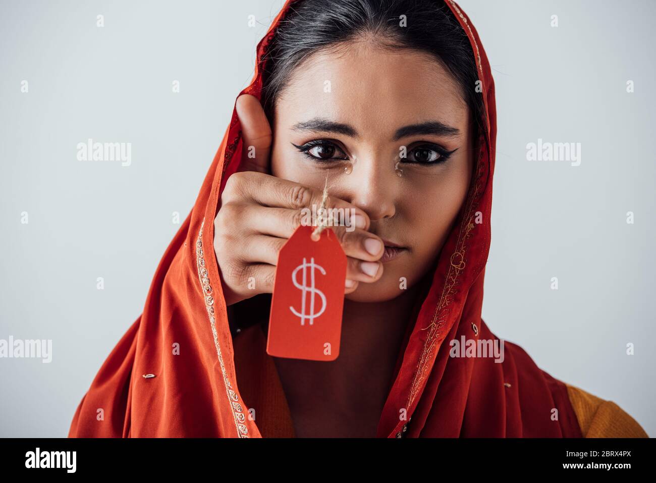 Male hand holding price tag with dollar sign near face of crying indian ...