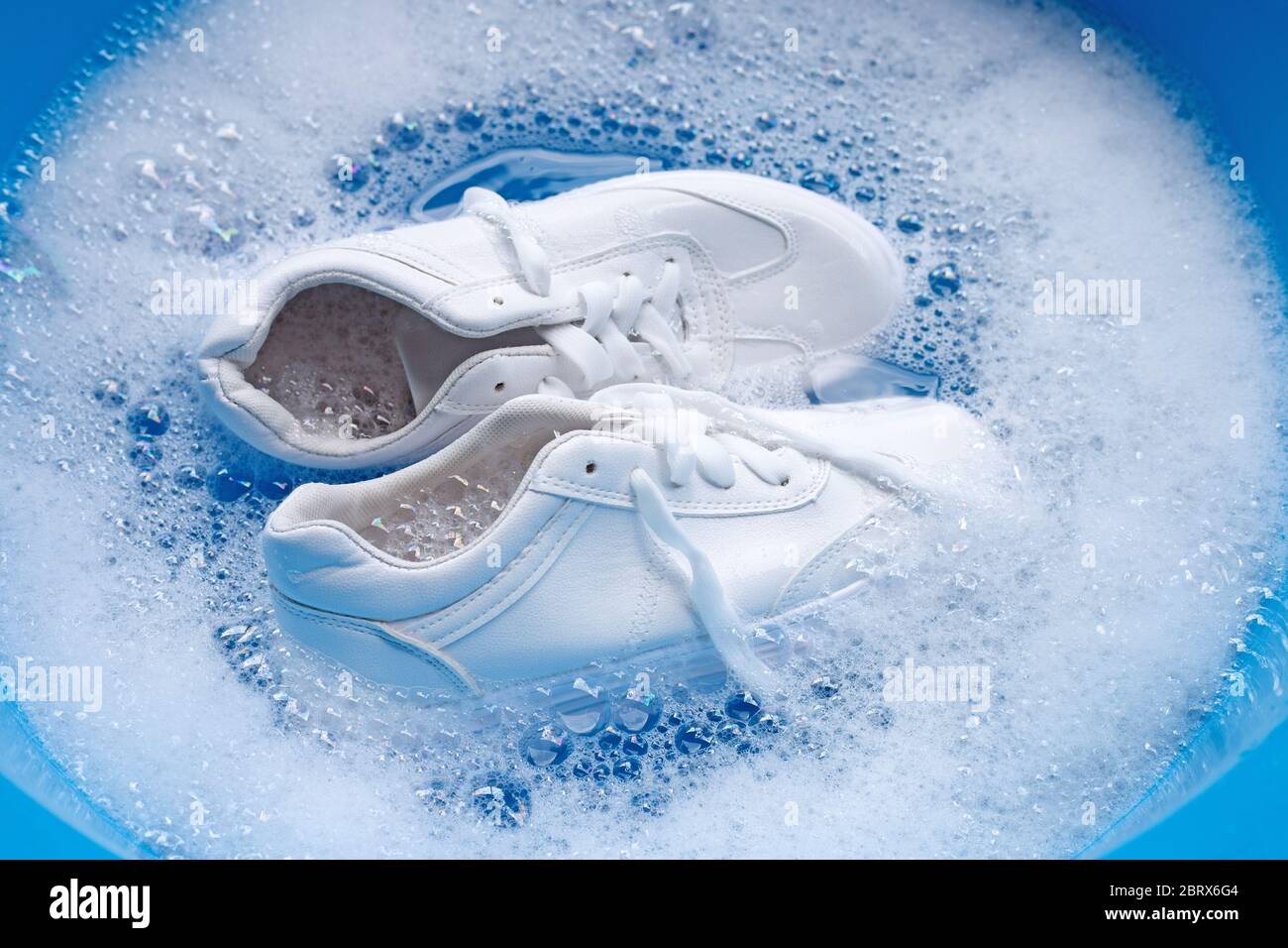 Soak shoes before washing. Cleaning Dirty sneakers Stock Photo - Alamy