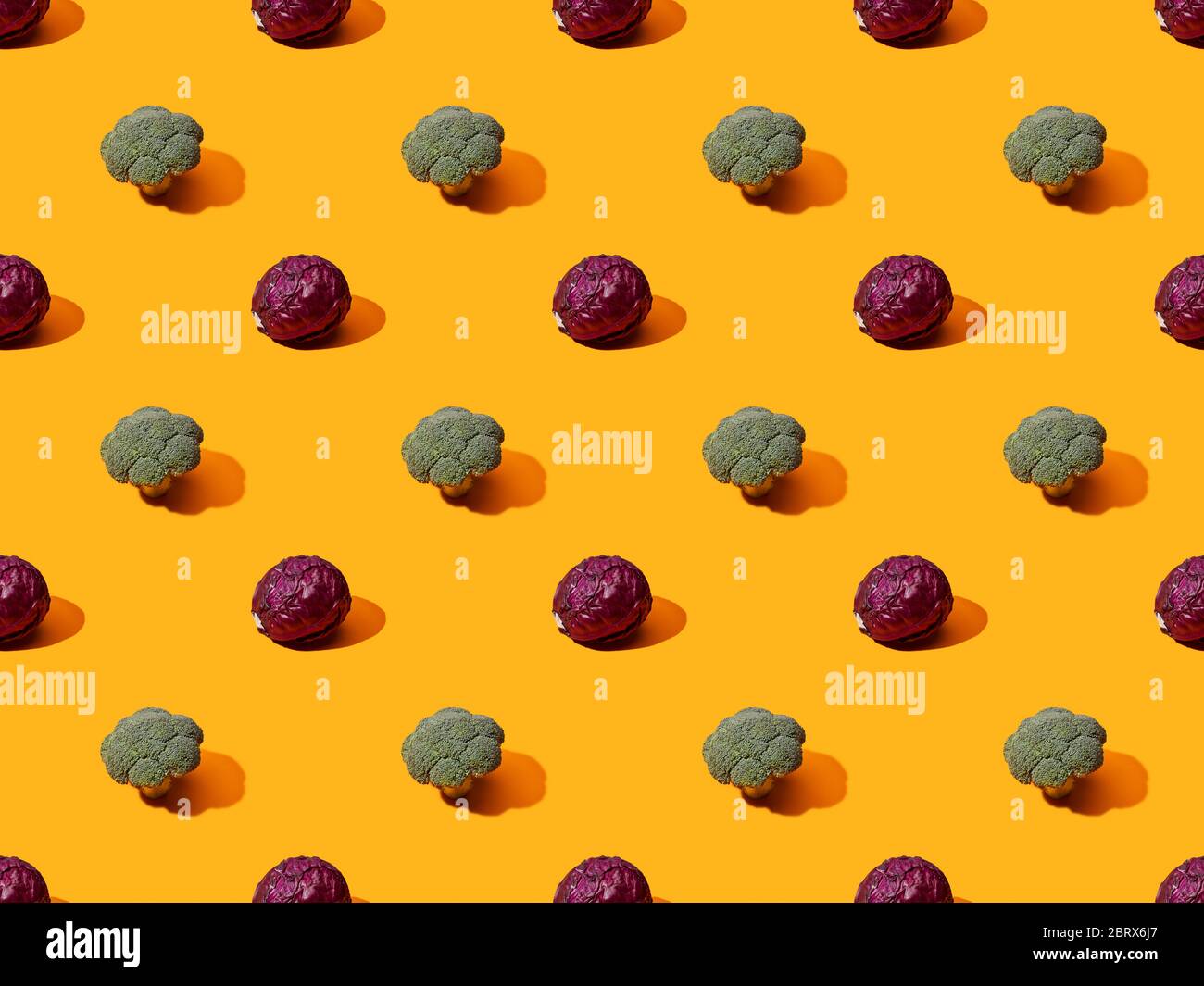 fresh green broccoli and red cabbage on orange background, seamless ...