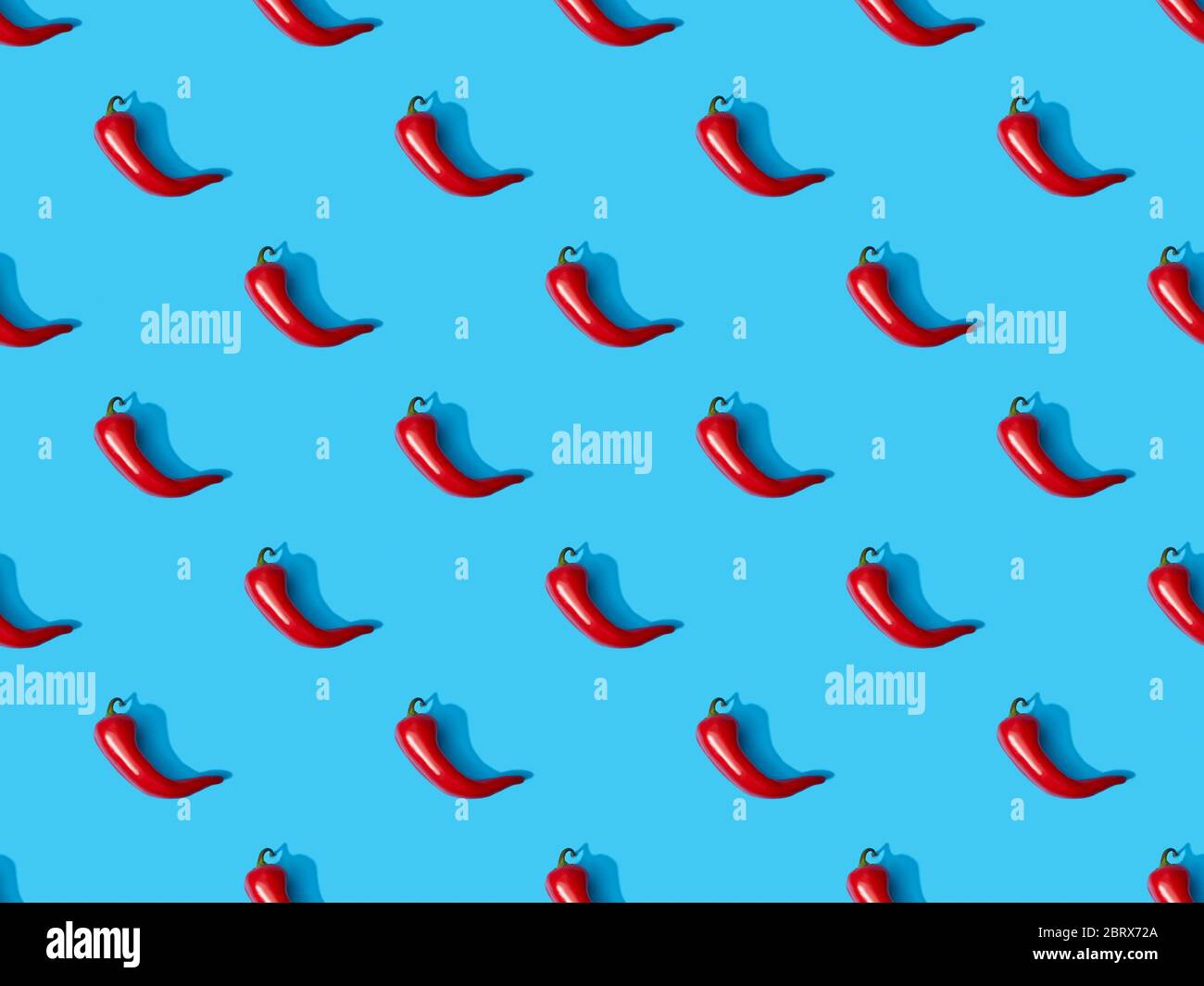 top view of red spicy chili peppers on blue colorful background ...