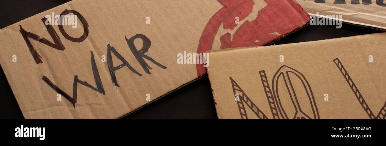 cardboard placards with no war lettering on black background, panoramic ...