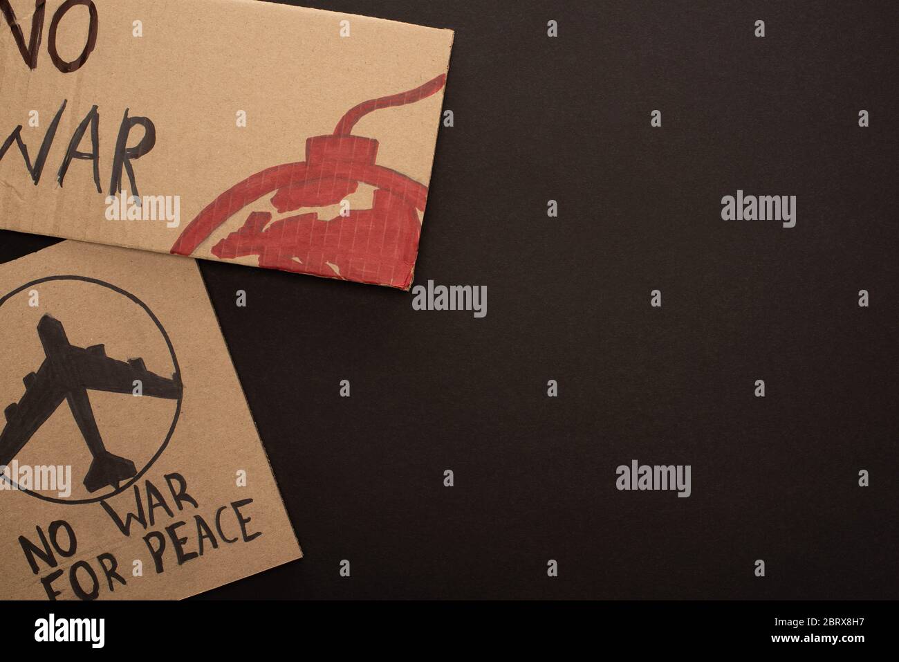top view of cardboard placards with no war lettering, plane and bomb on ...