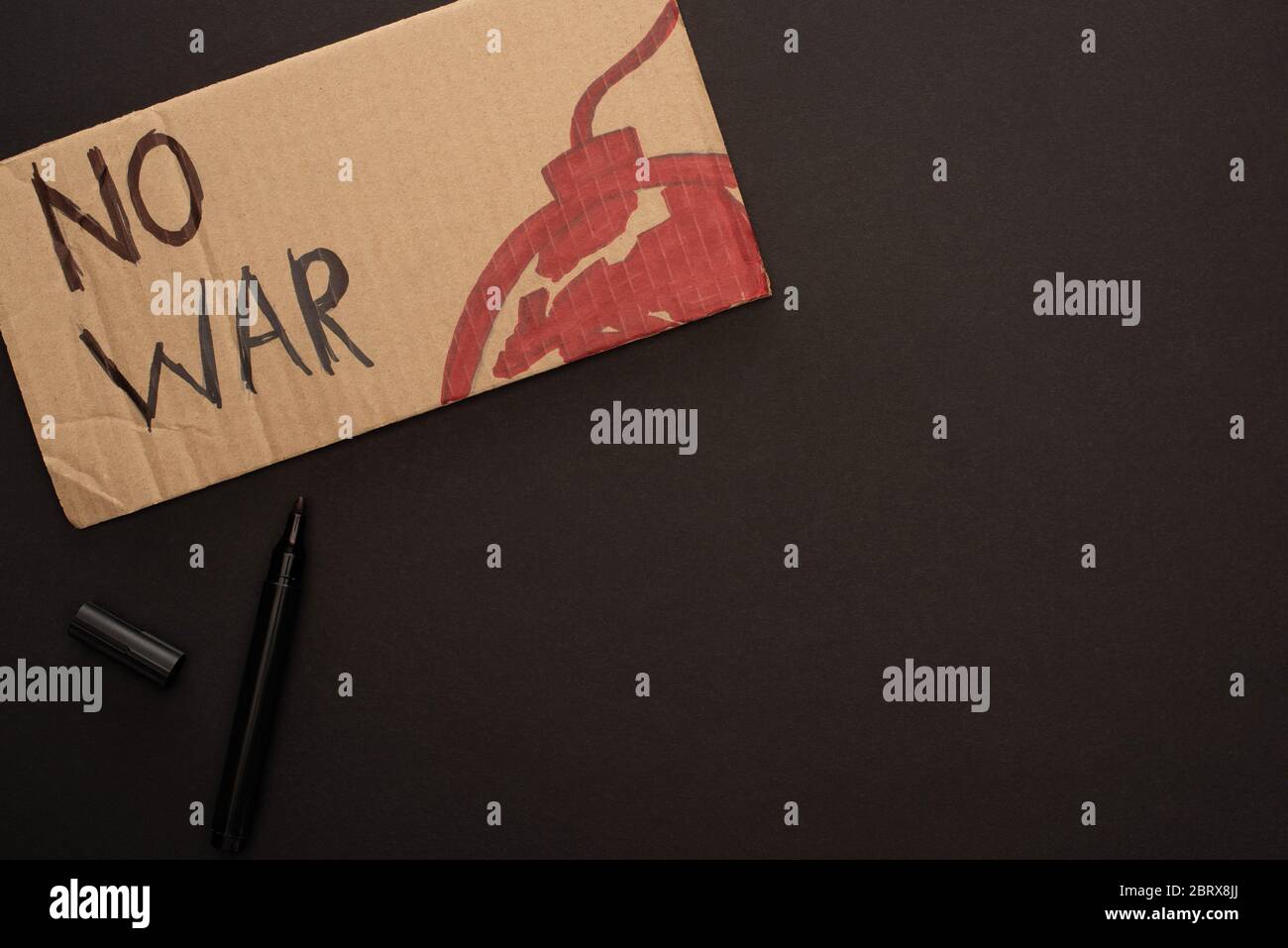 top view of marker and cardboard placard with no war lettering and bomb ...