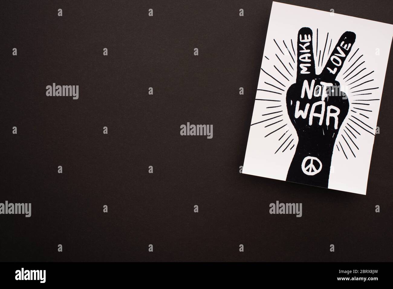 top view of white paper with hand drawing, peace sign and make love not ...