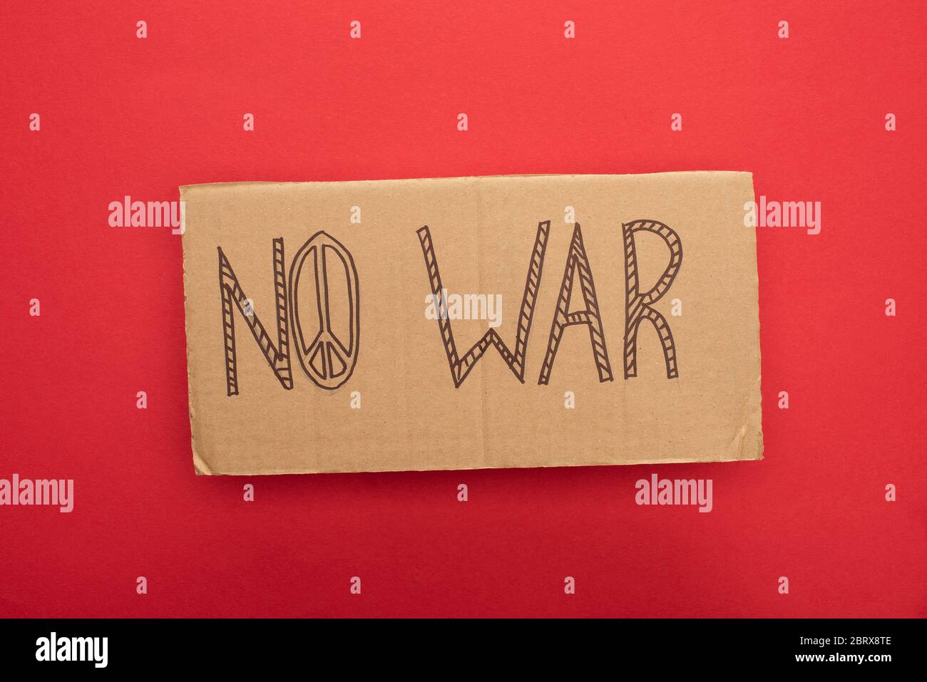 top view of cardboard placard with no war lettering and peace sign on ...