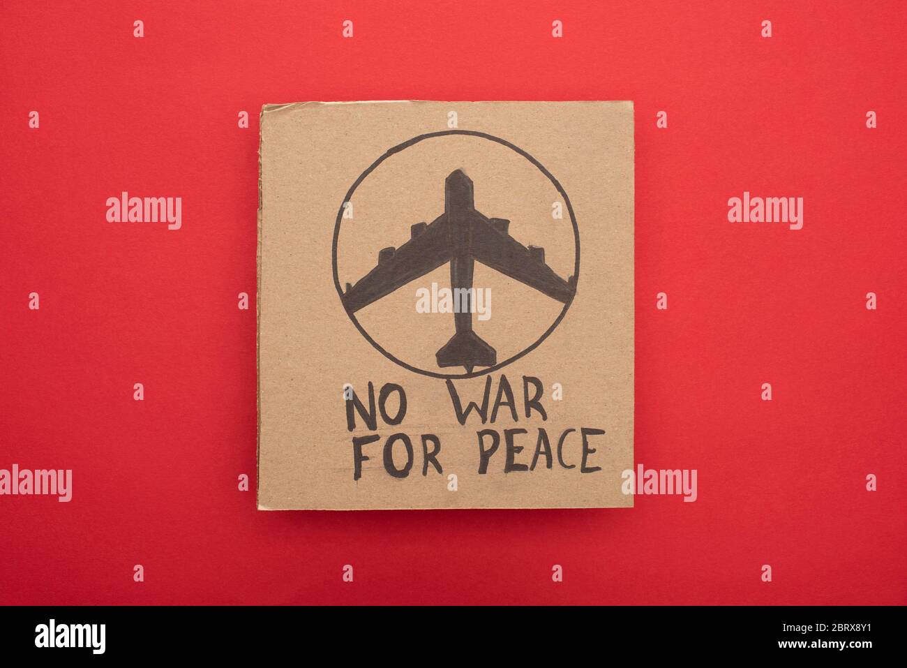top view of cardboard placard with no war fro peace lettering and ...