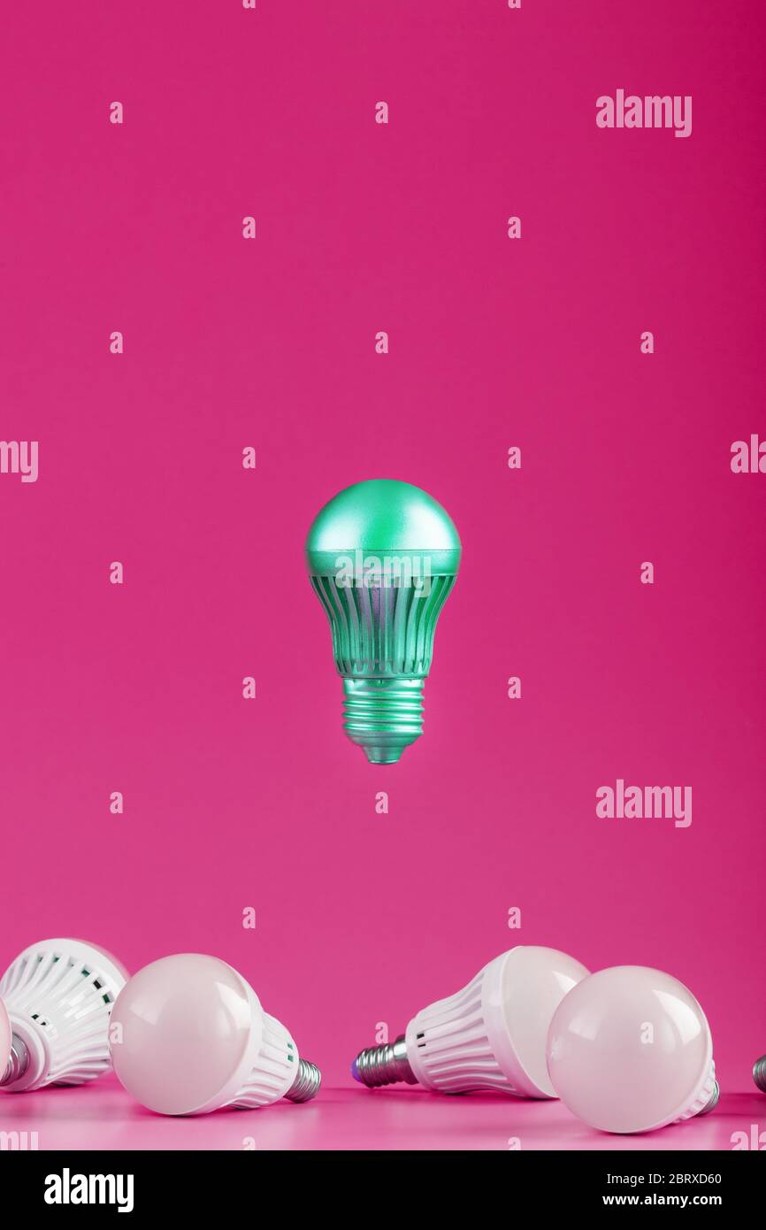 A special Light bulb hovers over simple, standard white light bulbs on ...