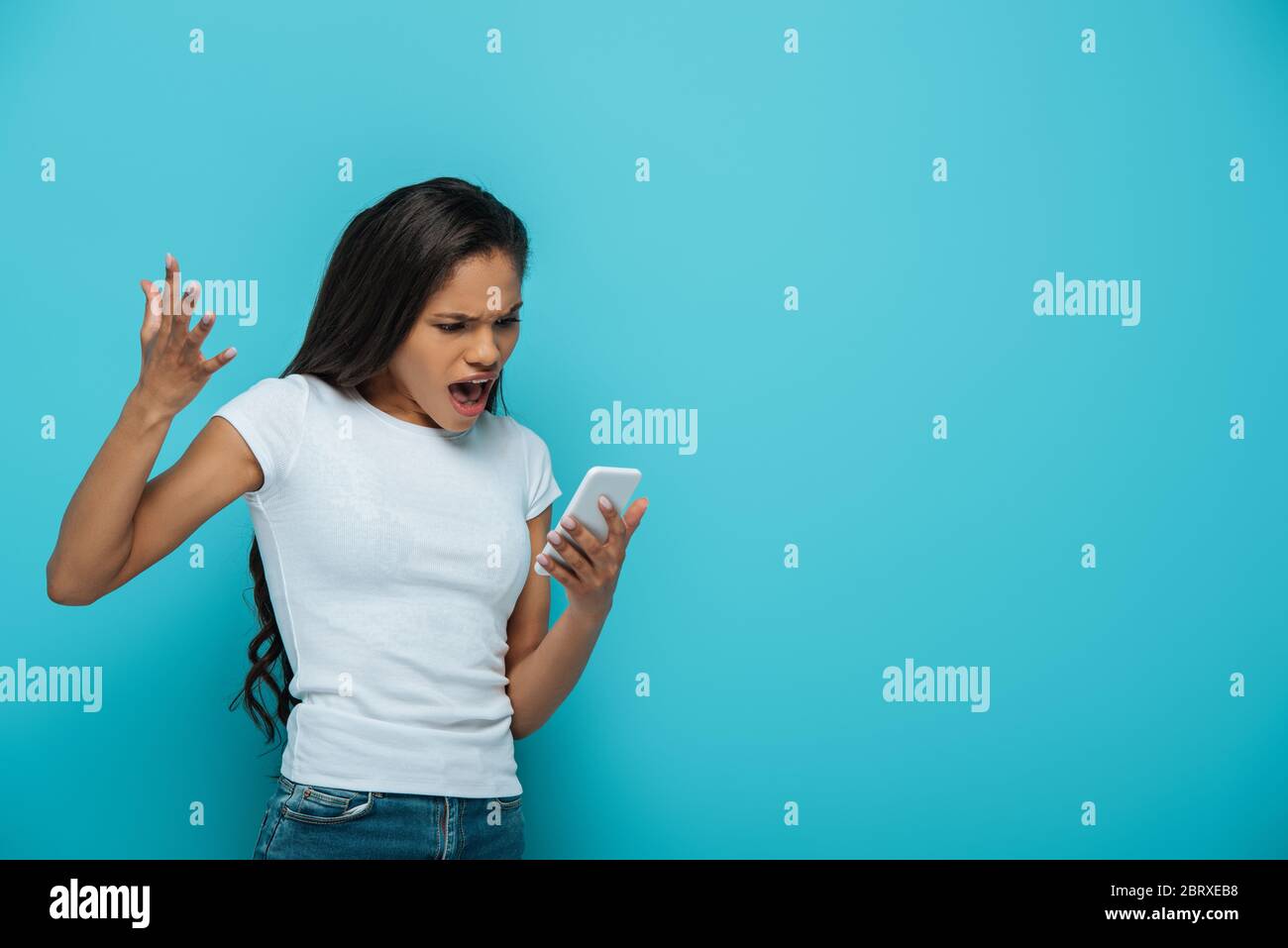 angry african american girl screaming during video call on smartphone ...